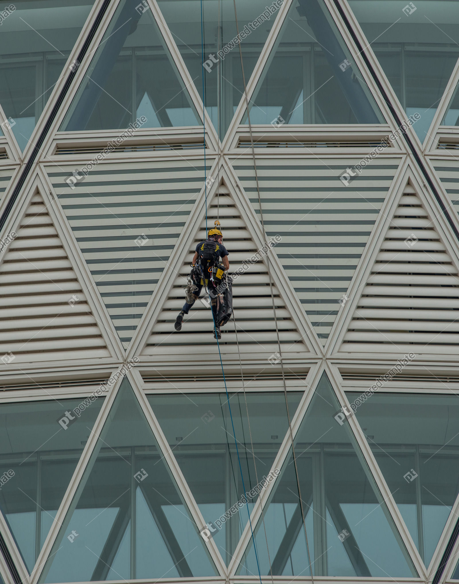 A Rope Operator with a Harness Lowering Himself onto the Facade of a ...