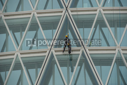 A Rope Operator with a Harness Lowering Himself onto the Facade of a ...